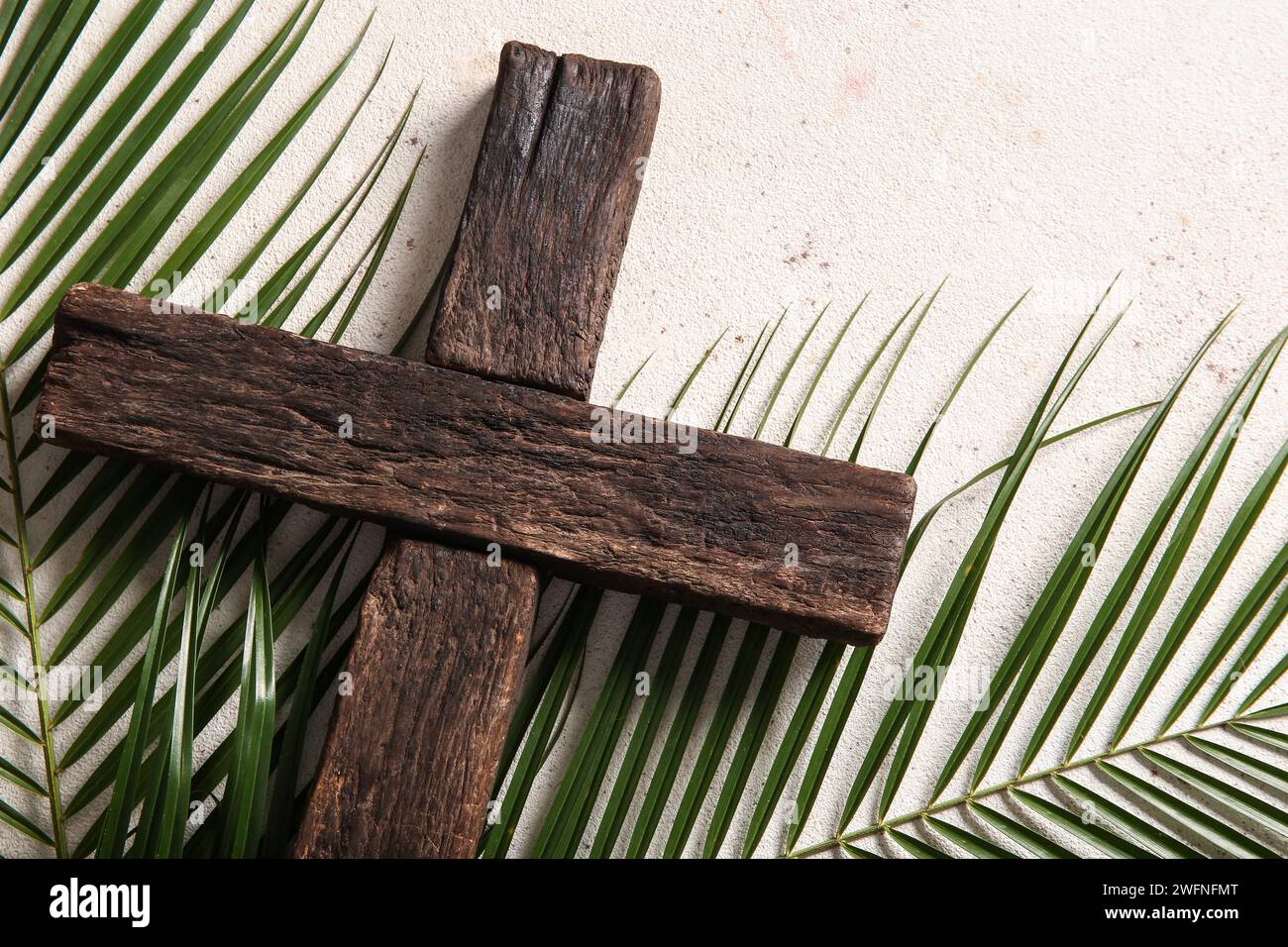 Wooden cross and palm leaves on white background Stock Photo - Alamy