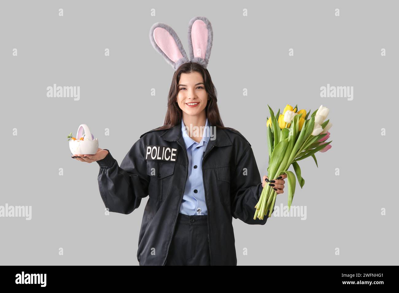 Female police officer in bunny ears with Easter eggs and tulips on ...
