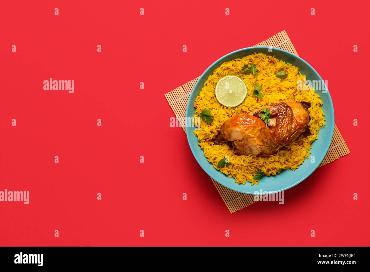Bowl of traditional chicken biryani on red background Stock Photo - Alamy