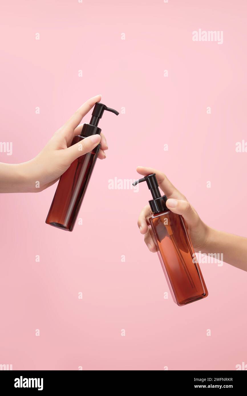 Two hand models holding pump bottle dispensers. Empty label for soap ...