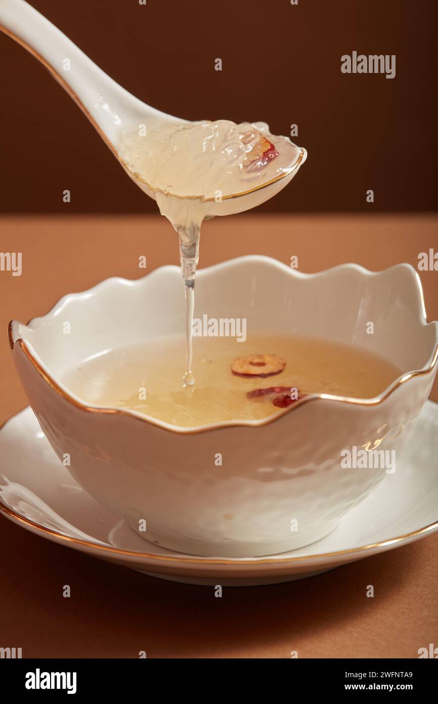 Edible bird nest soup with jujube in porcelain bowl, placed on a ...