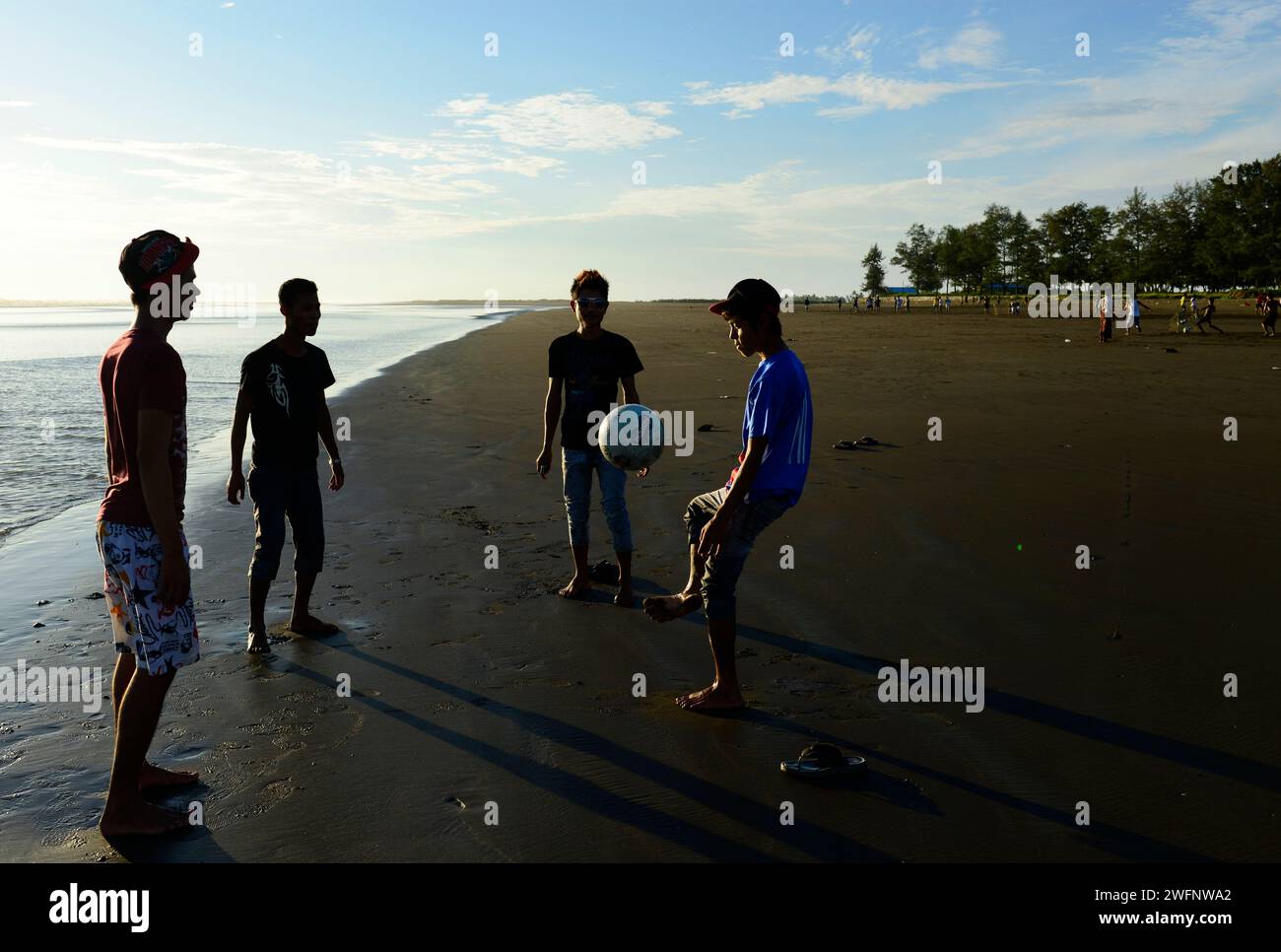 Arakanese men playing football on beach in Sittwe, Rakhine State ...