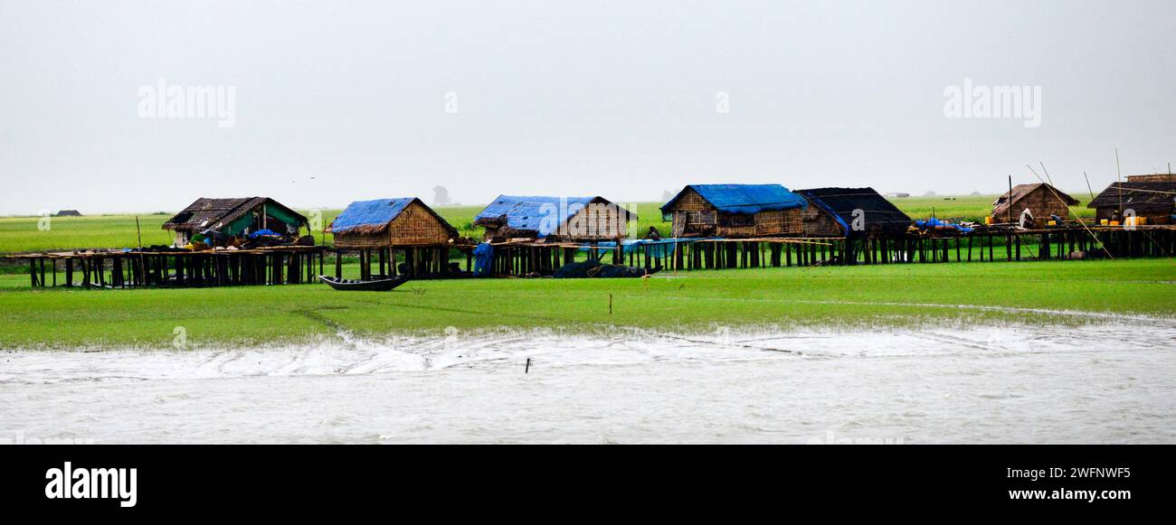 Stilt houses in a village on the bank of the Kaladan river in Rakhine ...