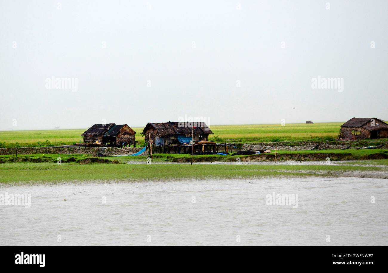 Stilt houses in a village on the bank of the Kaladan river in Rakhine ...