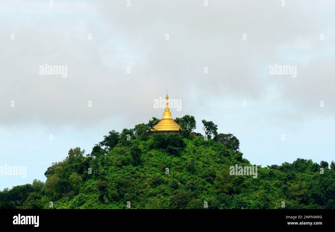 A Golden stupa on top of a hill by the Kaladan river near Mrauk U ...