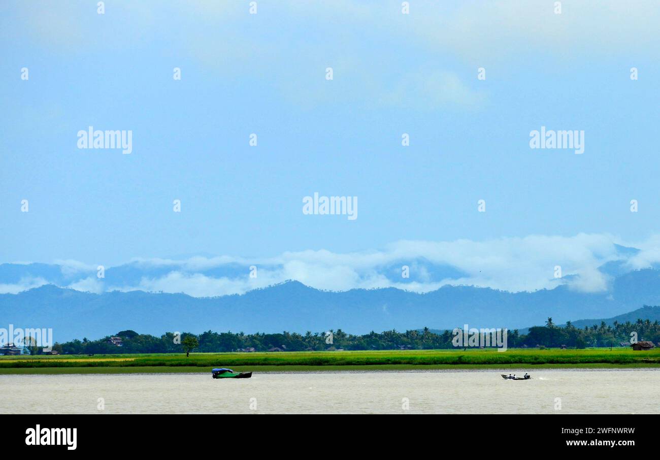 Misty mountains after a rainy morning seen from the Kaladan river in ...