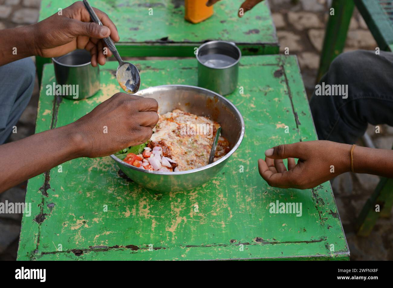 Locals enjoying egg & tomato sauce Dabo firfir in a s mall restaurant ...