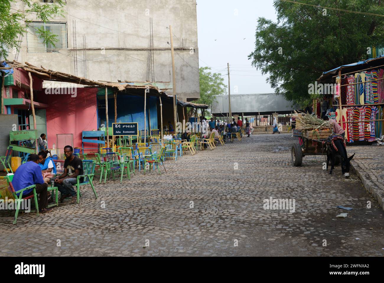 Locals enjoying egg & tomato sauce Dabo firfir in a s mall restaurant ...
