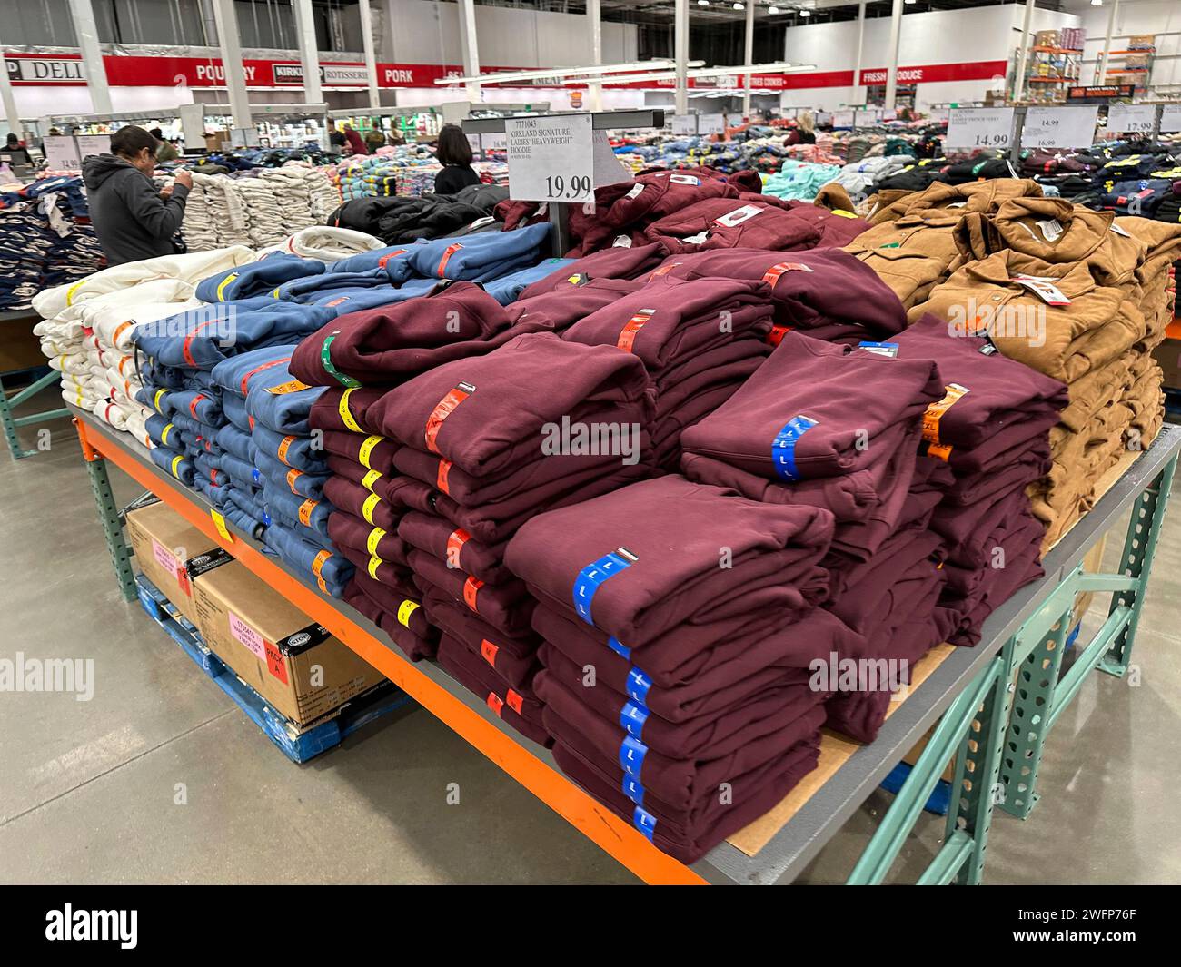 Shoppers peruse stacks of hoodies on display in a Costco warehouse ...
