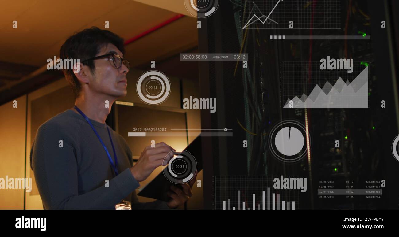 Image of processing circles and graphs over asian man working in server ...