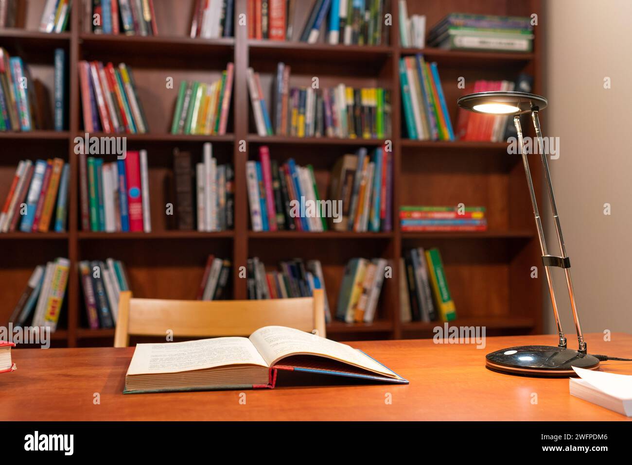 Open book on the table in library Stock Photo - Alamy