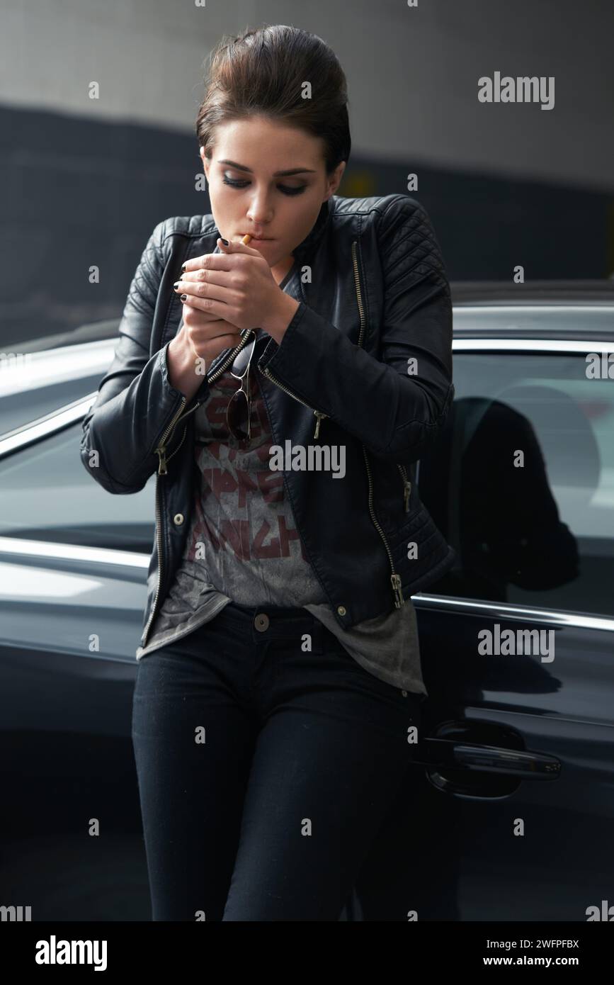 Woman, car and smoking cigarette in parking lot while waiting for pick ...