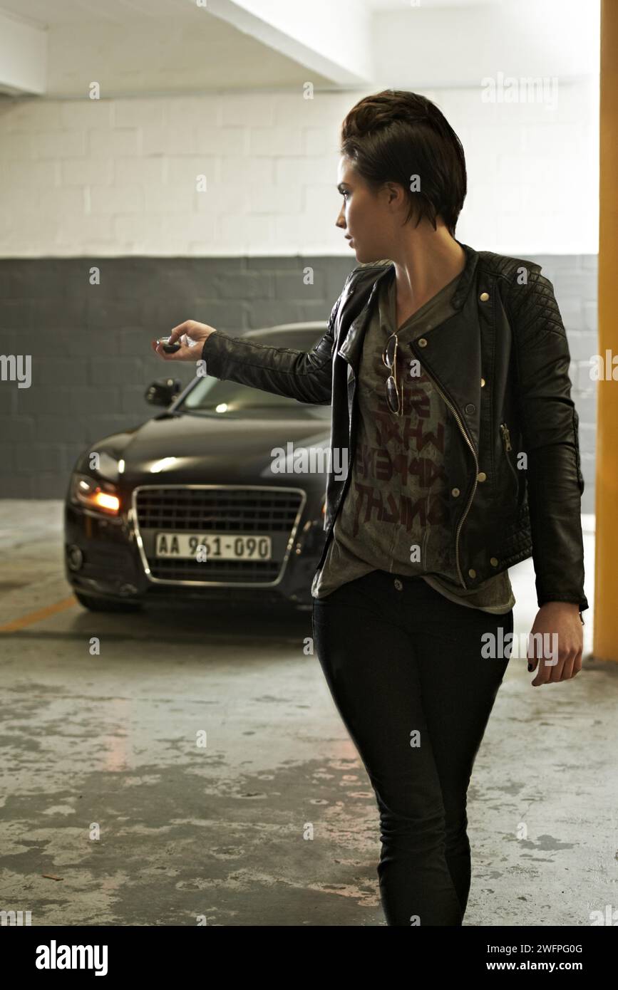 Woman, parking and lock car with cool punk style in garage for safety ...