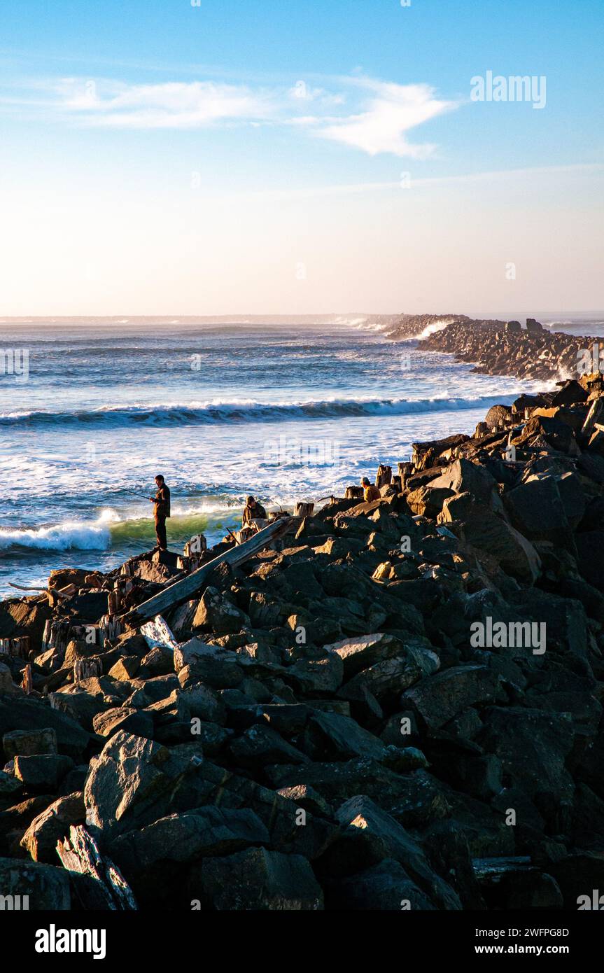 Fisherman on a jetty outside Fort Steven's State Park, Oregon Stock ...