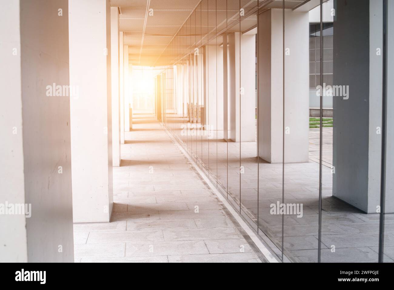 A spacious corridor of a modern building with columns Stock Photo - Alamy