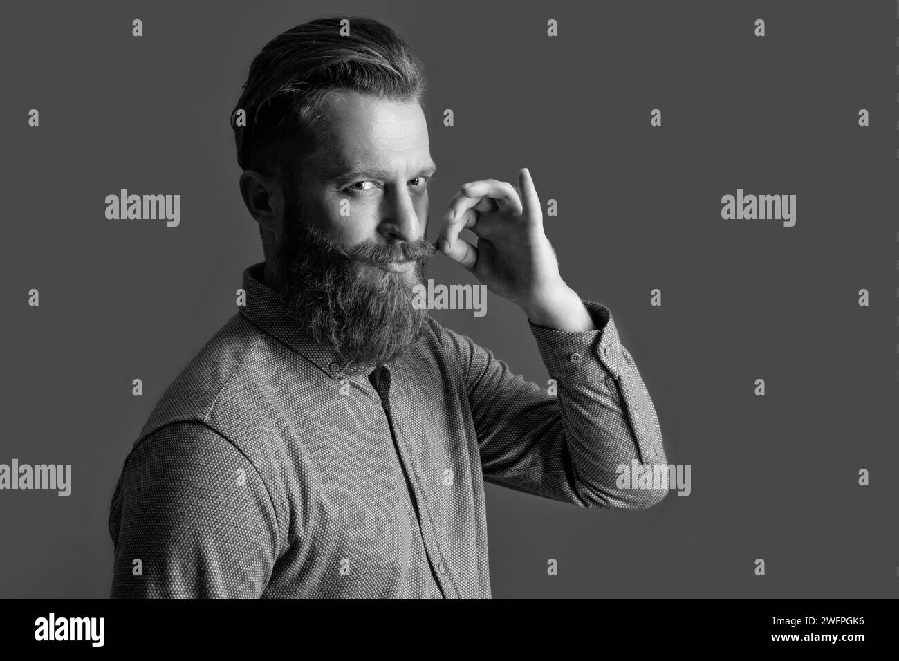 Irish man twirling mustache half turn. Bearded man twisting mustache ...