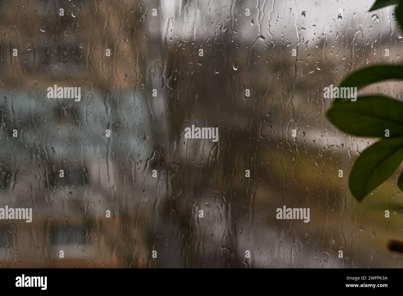 Raindrops falling down window glass hi-res stock photography and images - Alamy