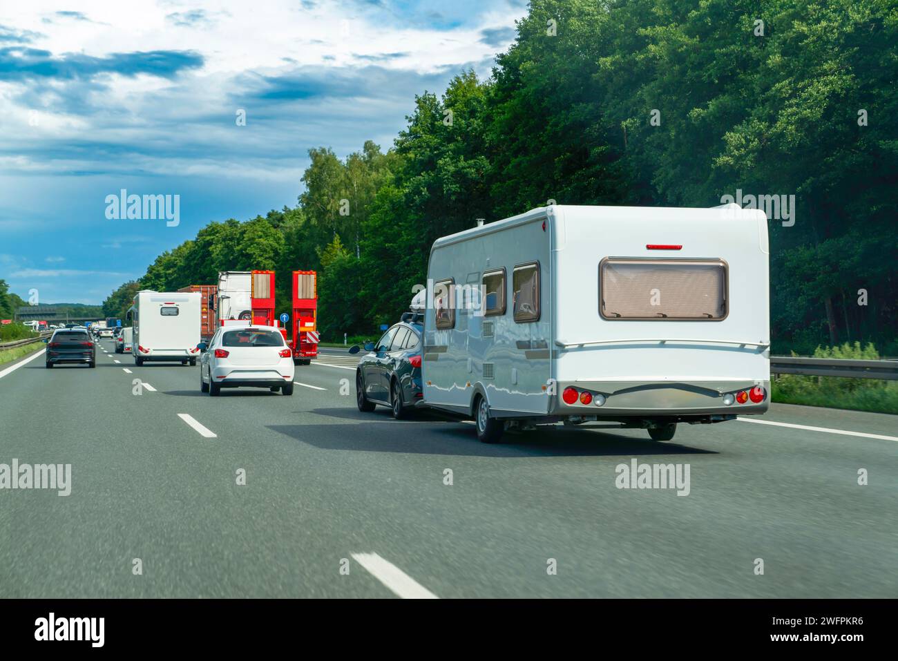 Caravan driving on asphalt road between Germany and Austria Stock Photo ...
