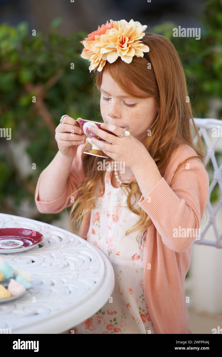 Girl, child and drinking tea in garden with party for birthday ...