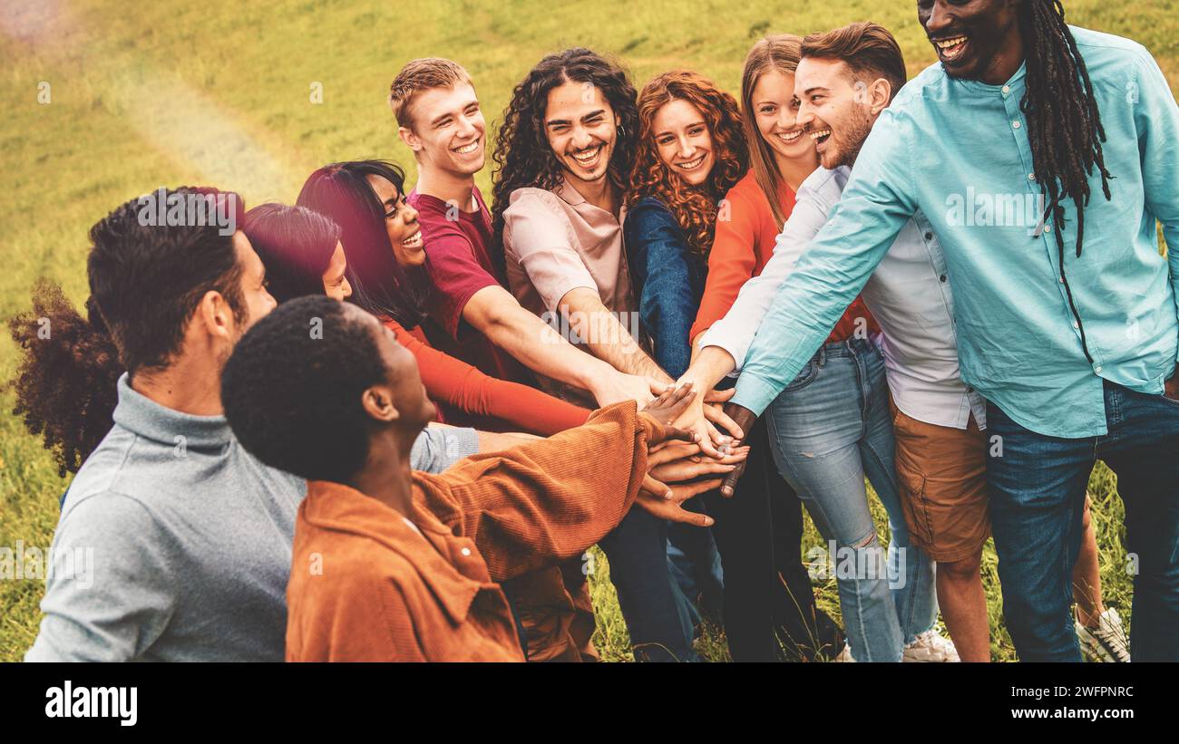Enthusiastic friends join hands outdoors, showcasing team spirit and unity amidst nature Stock ...