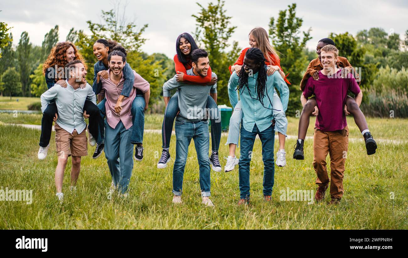 Group of happy young adults bonding, laughing, and enjoying a sunny day ...