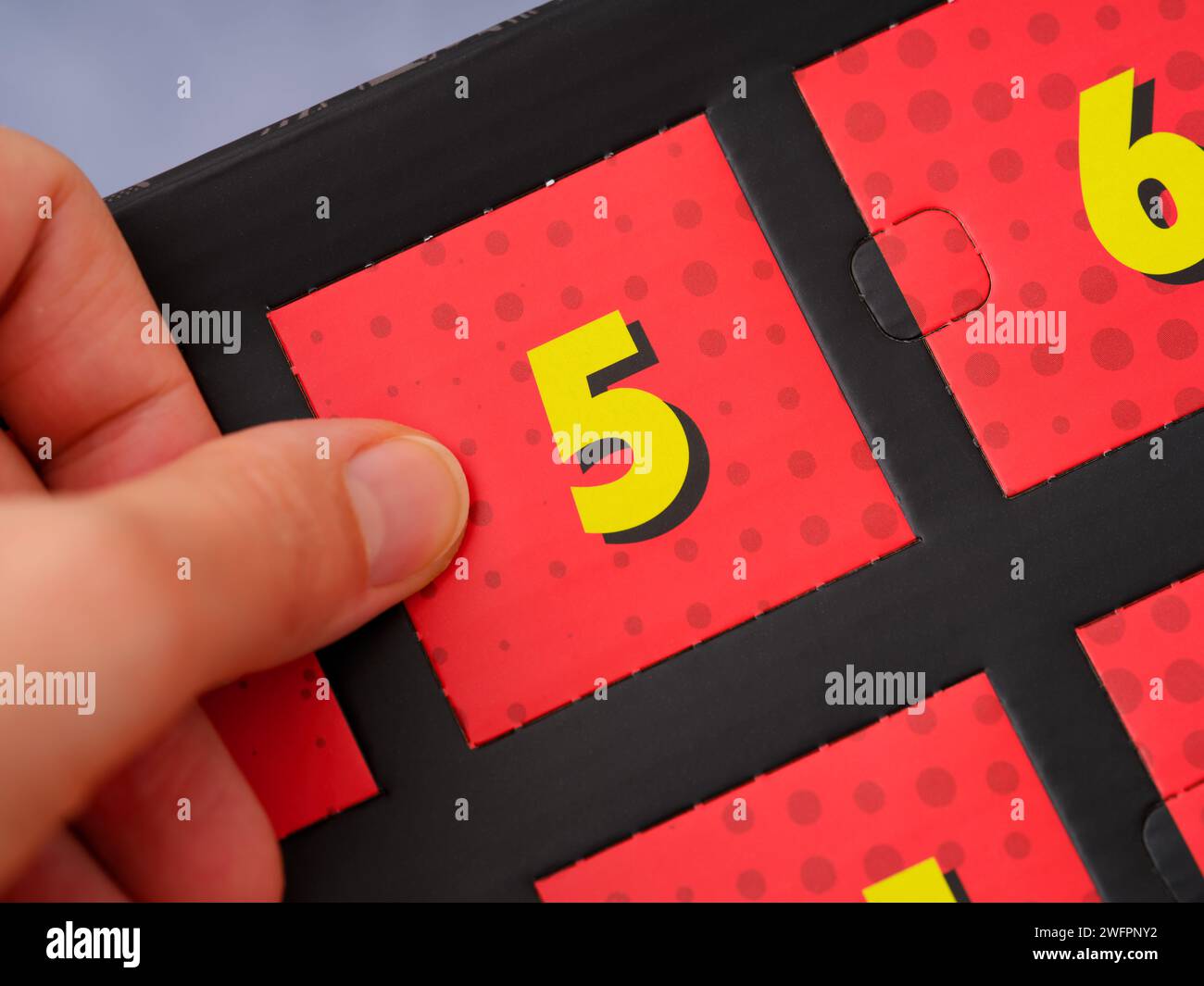 A woman hand opening a door with number 5 on an advent calendar Stock ...
