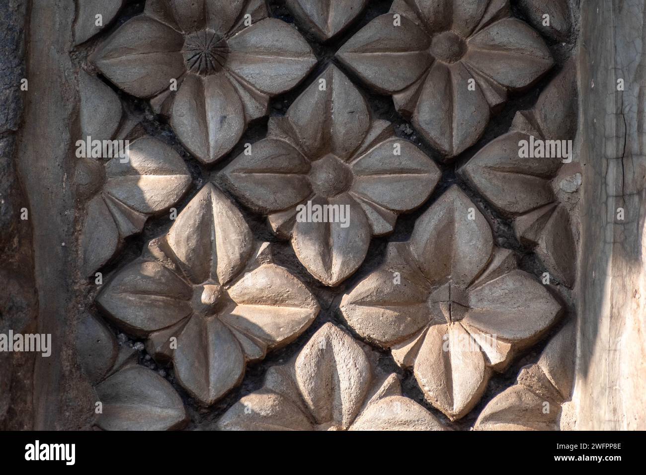 Abstract floral motifs and carvings on the stone walls of the ancient ...