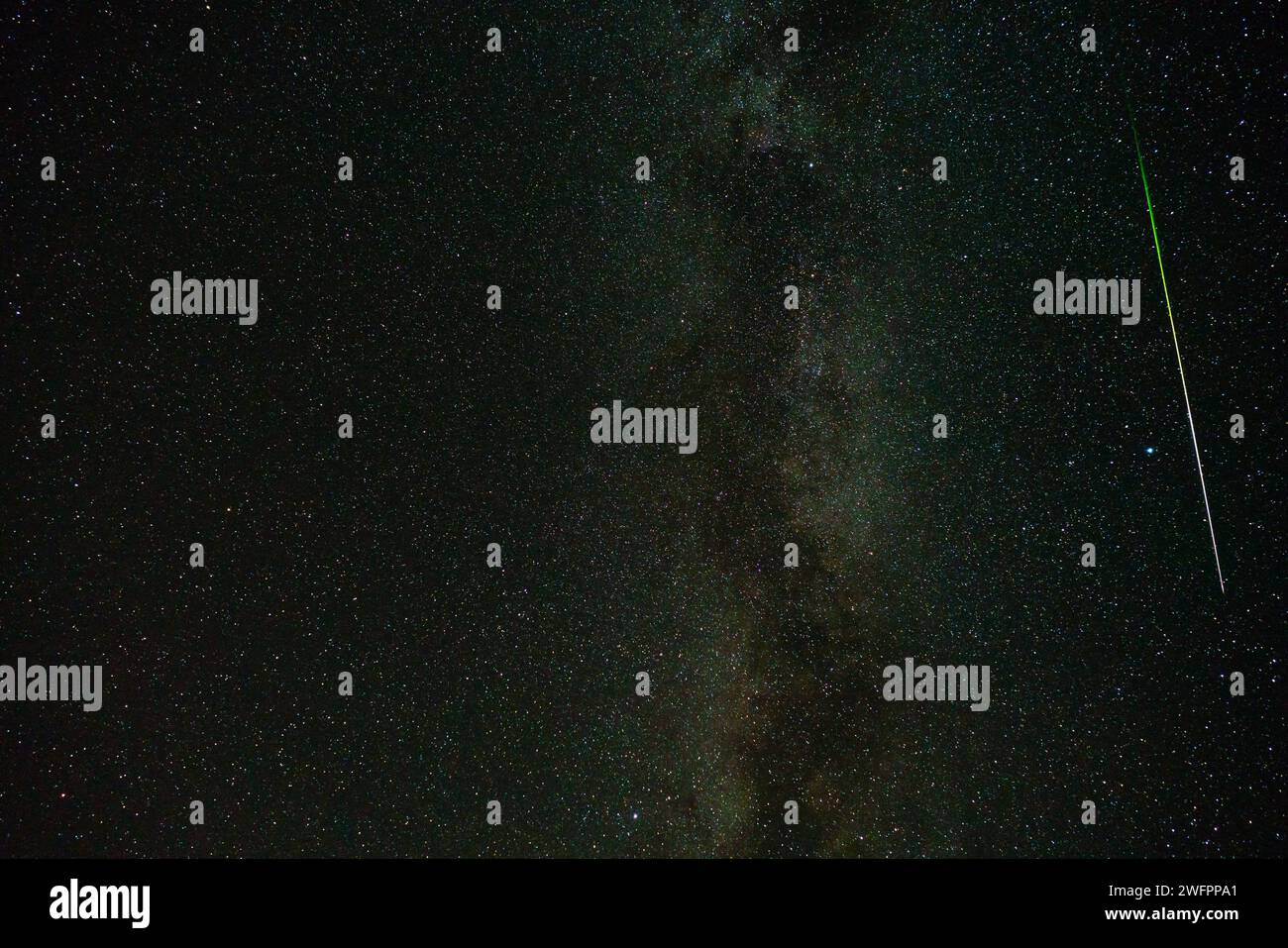 Milky way galaxy and the trail of a falling meteor Stock Photo - Alamy