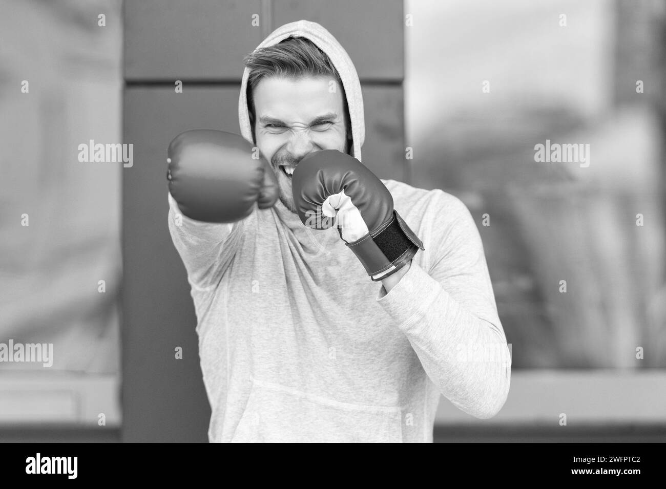 angry man boxing. man boxing in hoodie and gloves. man boxing outdoor ...