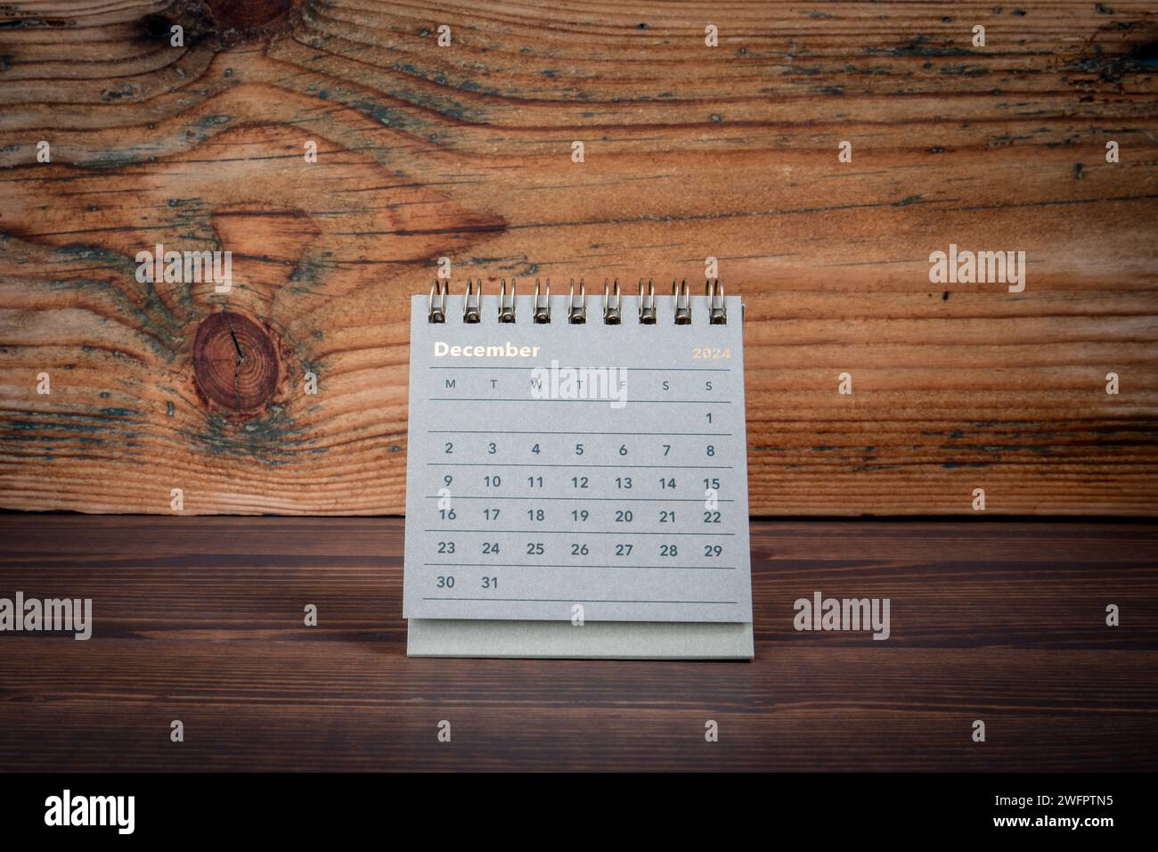 DECEMBER 2024. Cardboard desk calendar on a wooden texture background ...