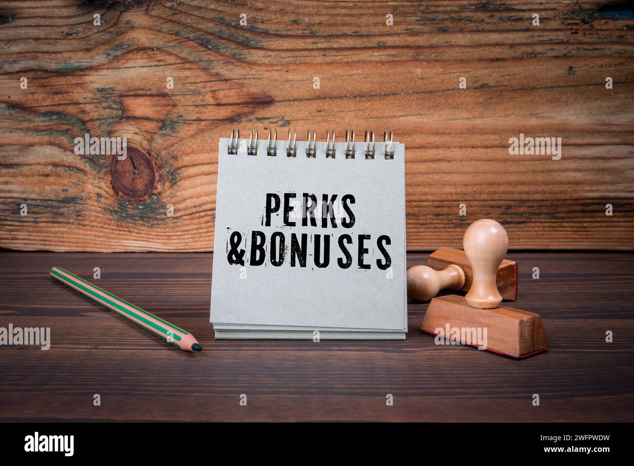 PERKS AND BONUSES. Cardboard notepad on wooden texture table Stock ...