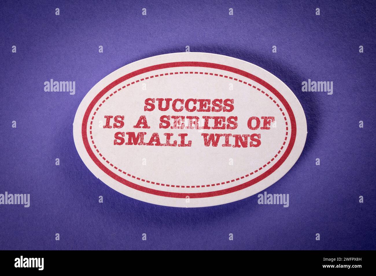Success is a series of small wins. Paper sticky note with text on a ...