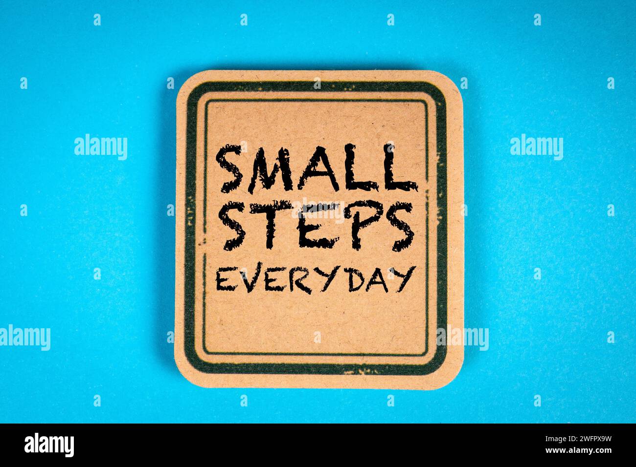 Small Steps Everyday. Cardboard sticker with text on a blue background ...