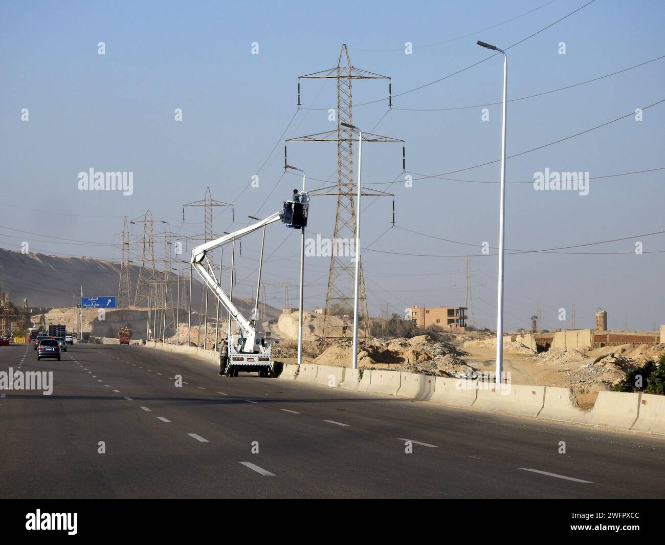 Giza, Egypt, January 7 2024: maintenance and repairing a street light ...