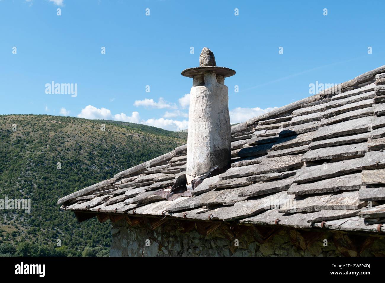 Stone roof tiles and chimney on traditional medieval house in old town ...