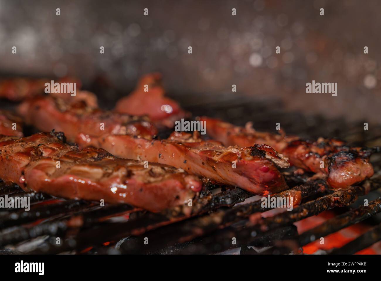 Lamb liver on the grill. A close-up of burning barbecue coals and lamb ...