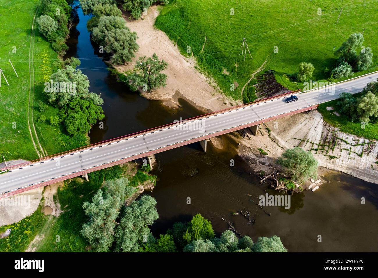 View from a drone of a road bridge over the river with cars driving ...