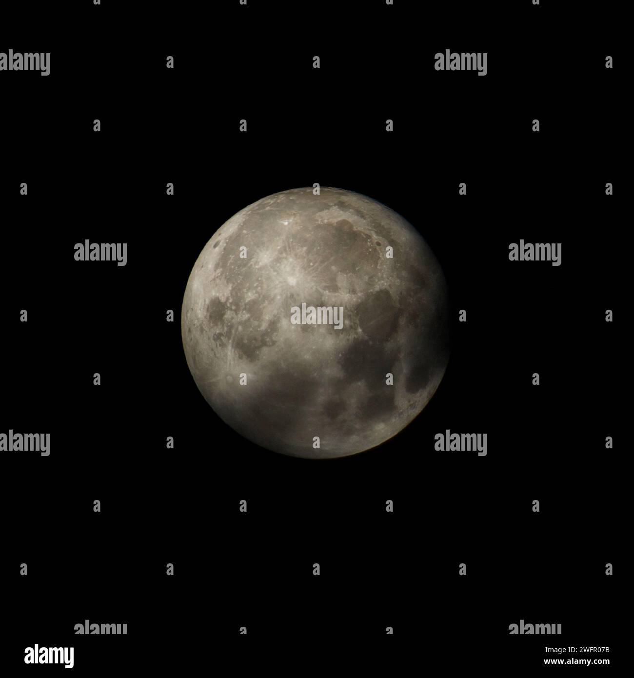 Black background and full moon. The full moon visible among the clouds ...