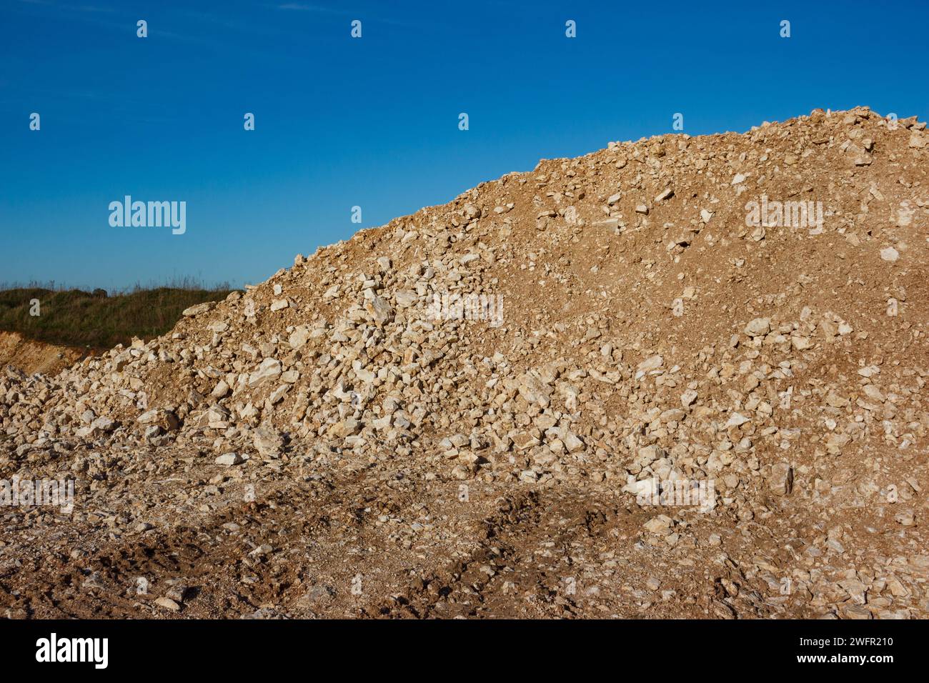 Mound of marble-like limestone fragments at a crushed stone quarry ...