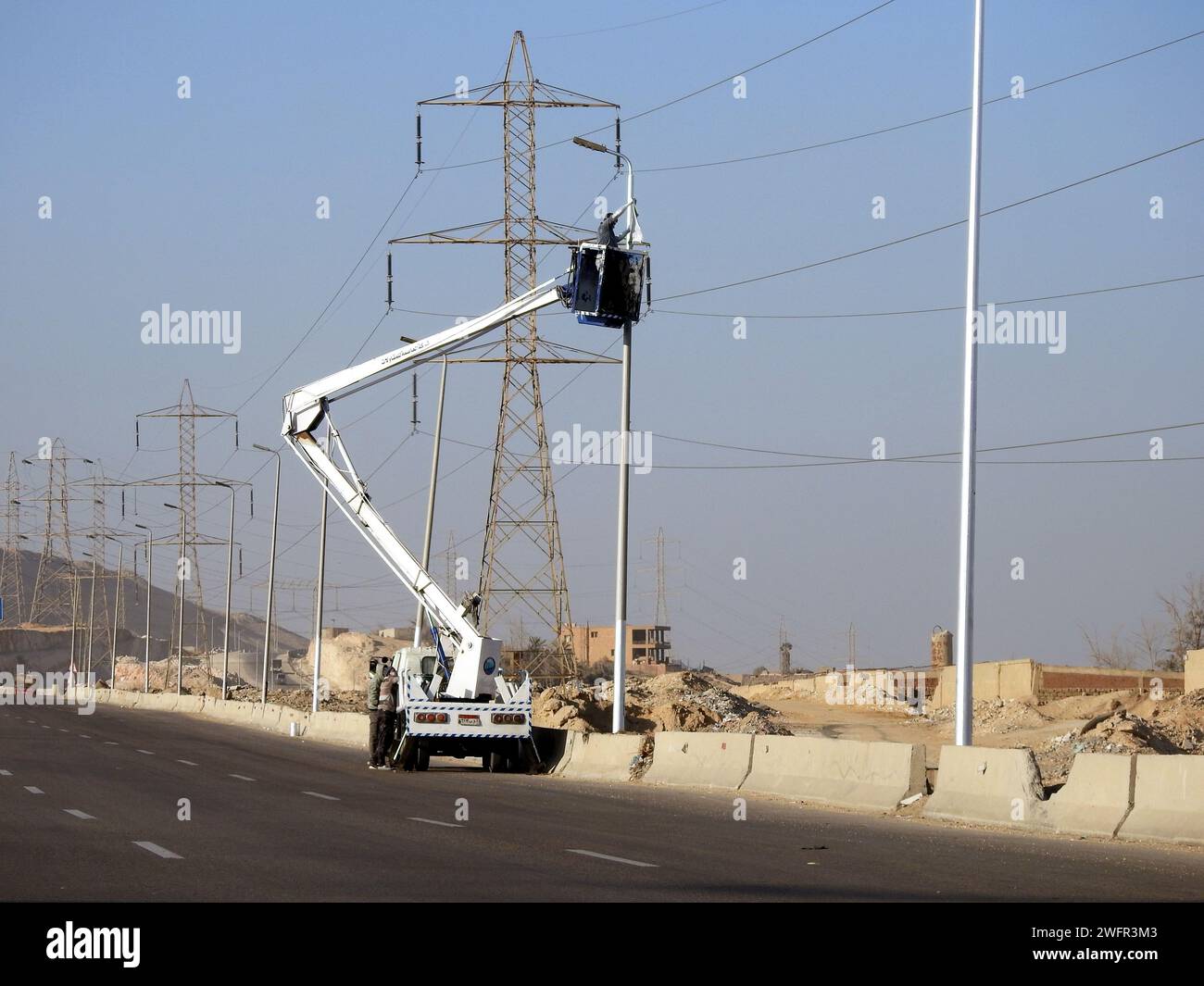 Giza, Egypt, January 7 2024: maintenance and repairing a street light ...