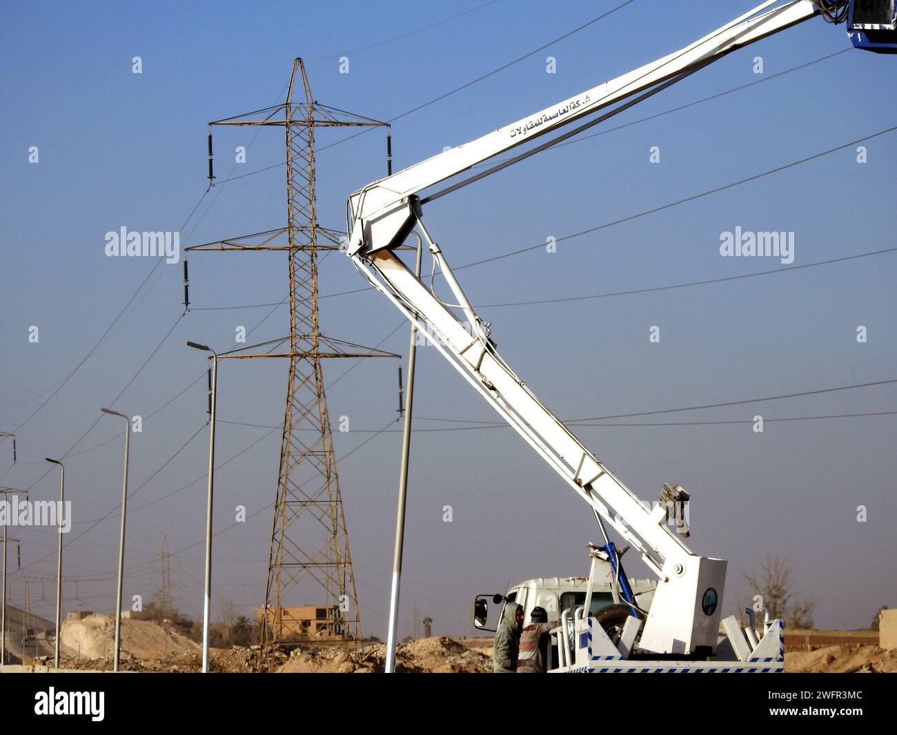 Giza, Egypt, January 7 2024: maintenance and repairing a street light ...