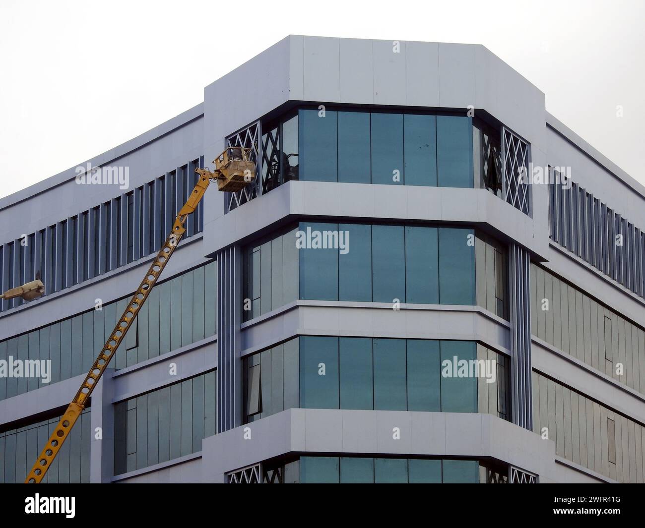 Cairo, Egypt, January 25 2024: Painting service and maintenance of the exterior of a building ...