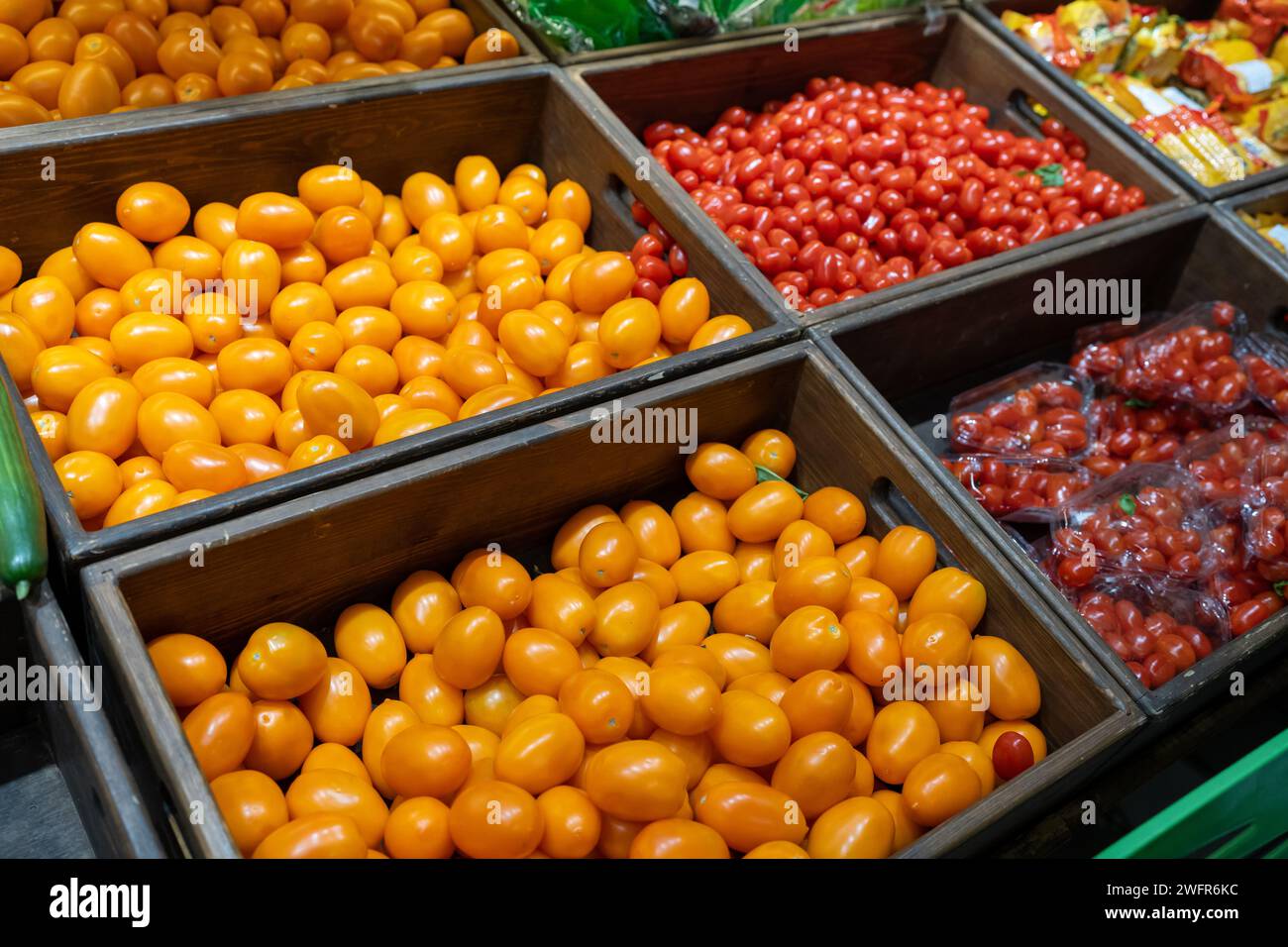 Tomatoes in wooden boxes in the fruit and vegetable section of a ...