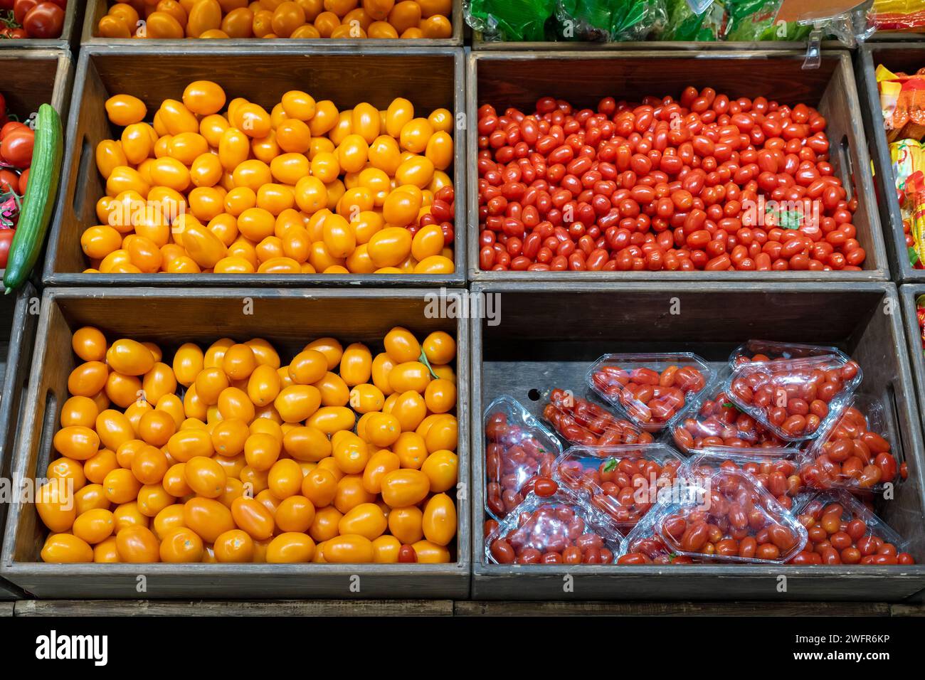 Tomatoes in wooden boxes in the fruit and vegetable section of a ...