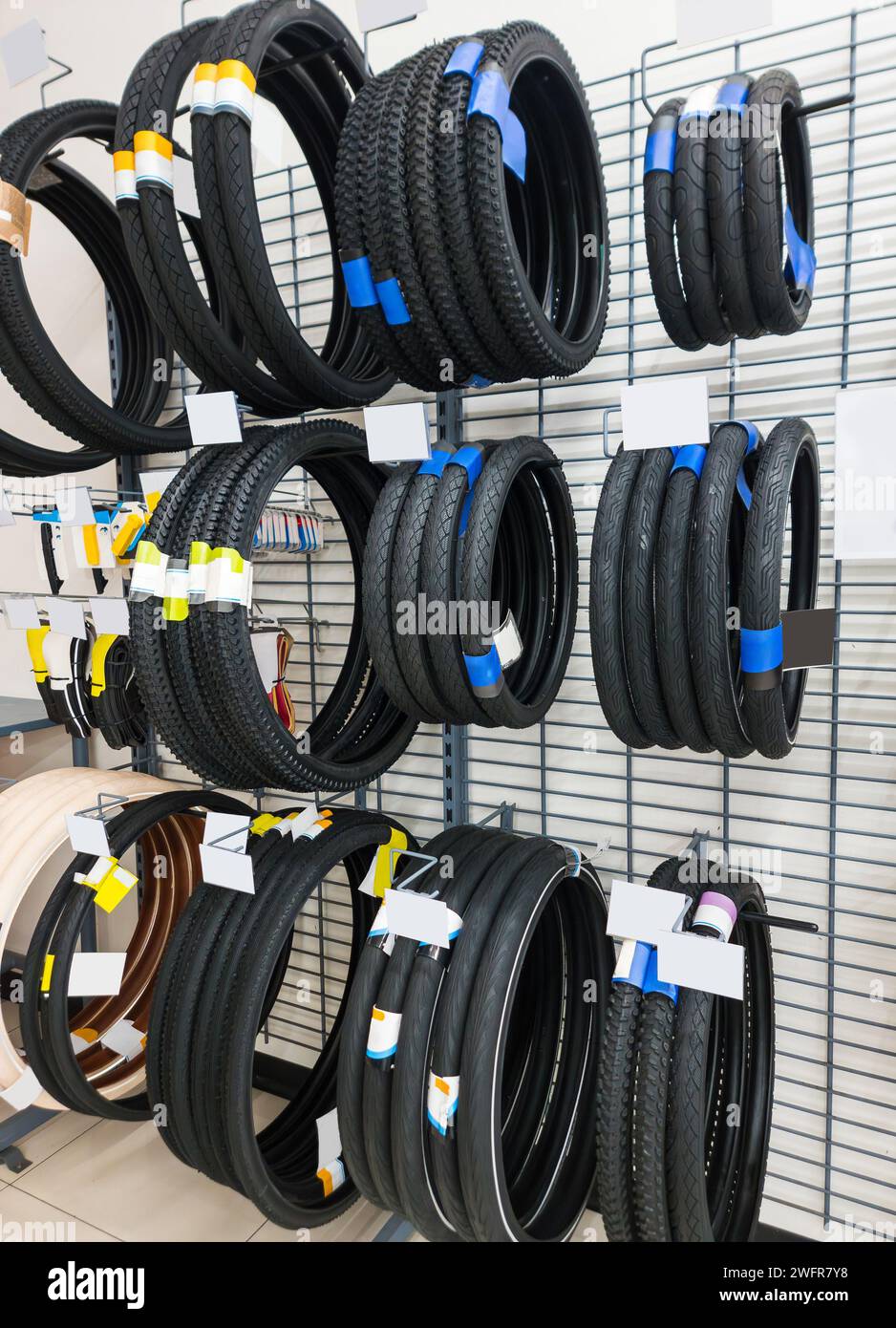 Rubber bicycle tires on shelves in sport shop Stock Photo - Alamy