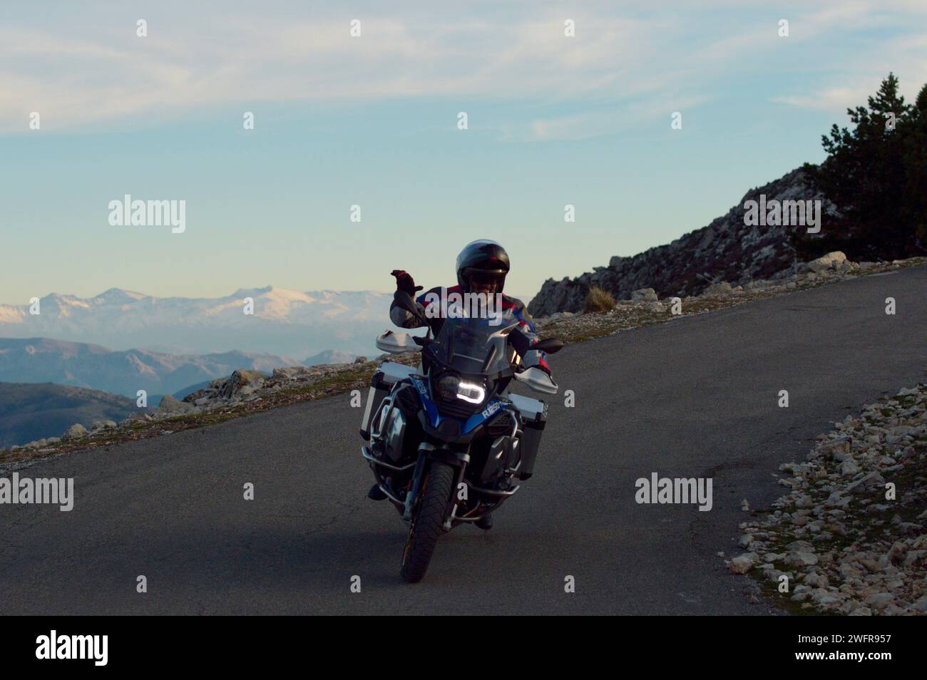 A joyous wave from a rider on a sport touring bike, embracing the freedom of the open road Stock ...