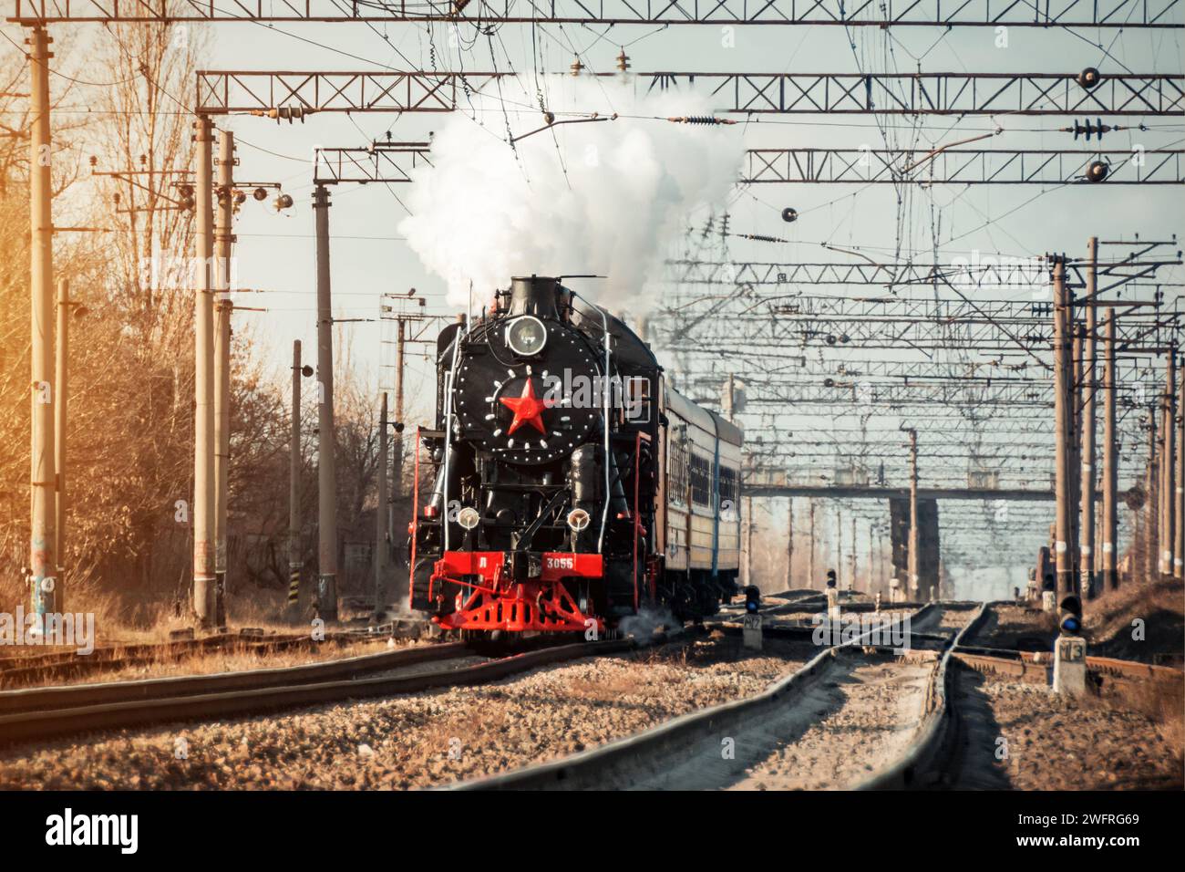 Steam locomotive with several railcars en tourist route round the city ...