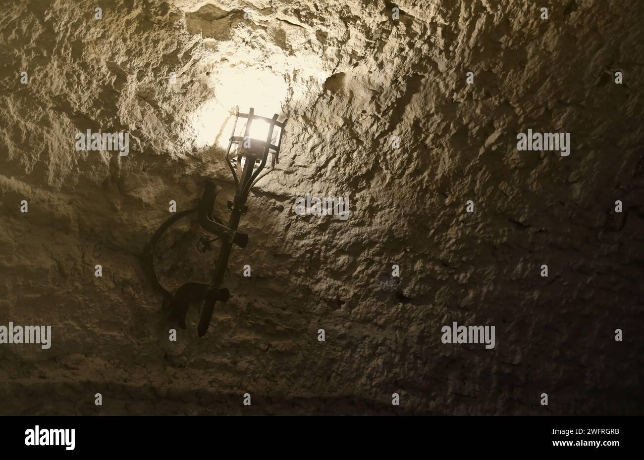 Lighted medieval castle torch hanging on a stone wall, vintage objects ...