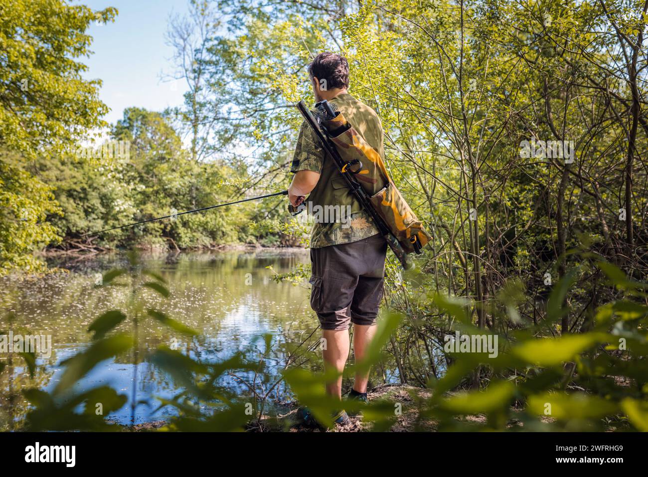 Recreational fisherman at river bank trying to catch a fish. Angler ...