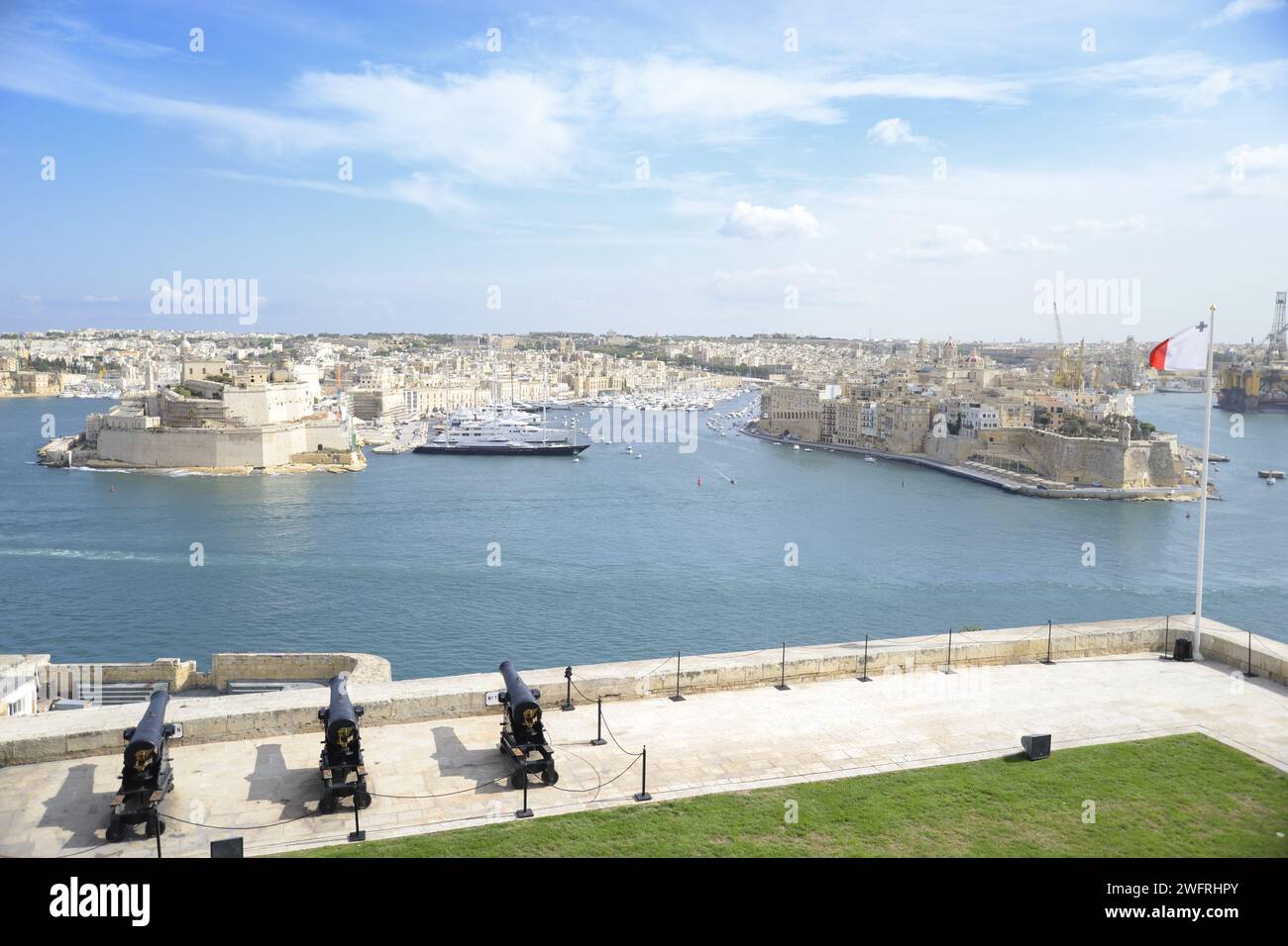 A scenic view of Valletta's historic fortified city and bustling harbor ...